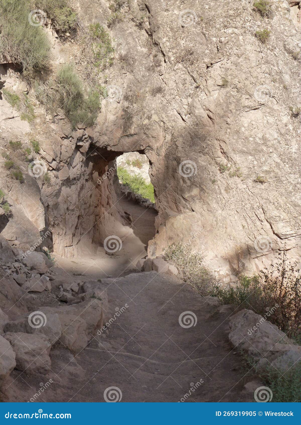 Vertical Shot of a Trail Passing through a Hole on a Cliff. Stock Image ...
