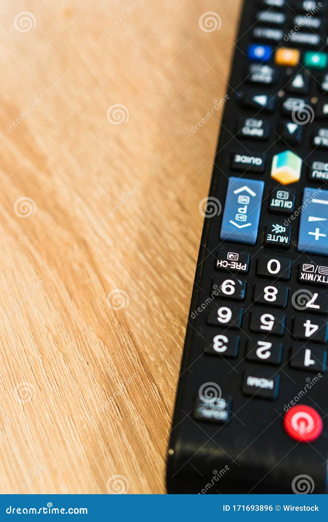 Vertical Shot of a Tv Remote Control on a Wooden Surface Stock Photo ...