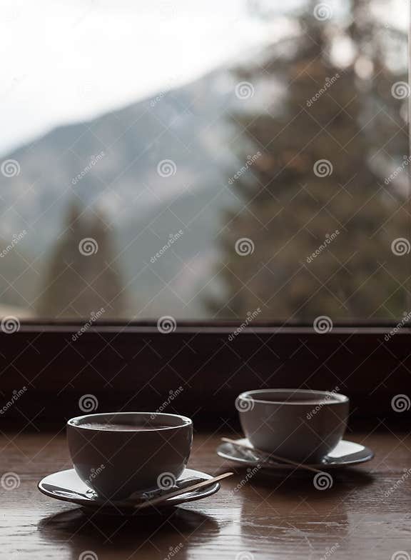 Vertical Shot of Two Coffee Cups on a Windowsill Stock Image - Image of ...