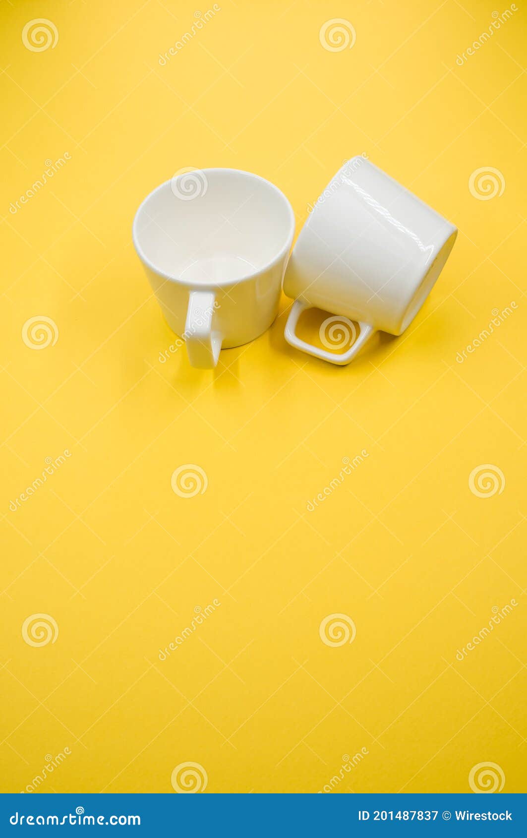 Vertical Shot of Two Empty Cups on a Yellow Surface Stock Image - Image ...
