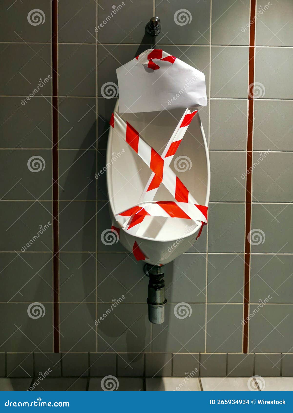 Vertical Shot of a Urinal for Men with a Barricade Tape Stock Photo ...