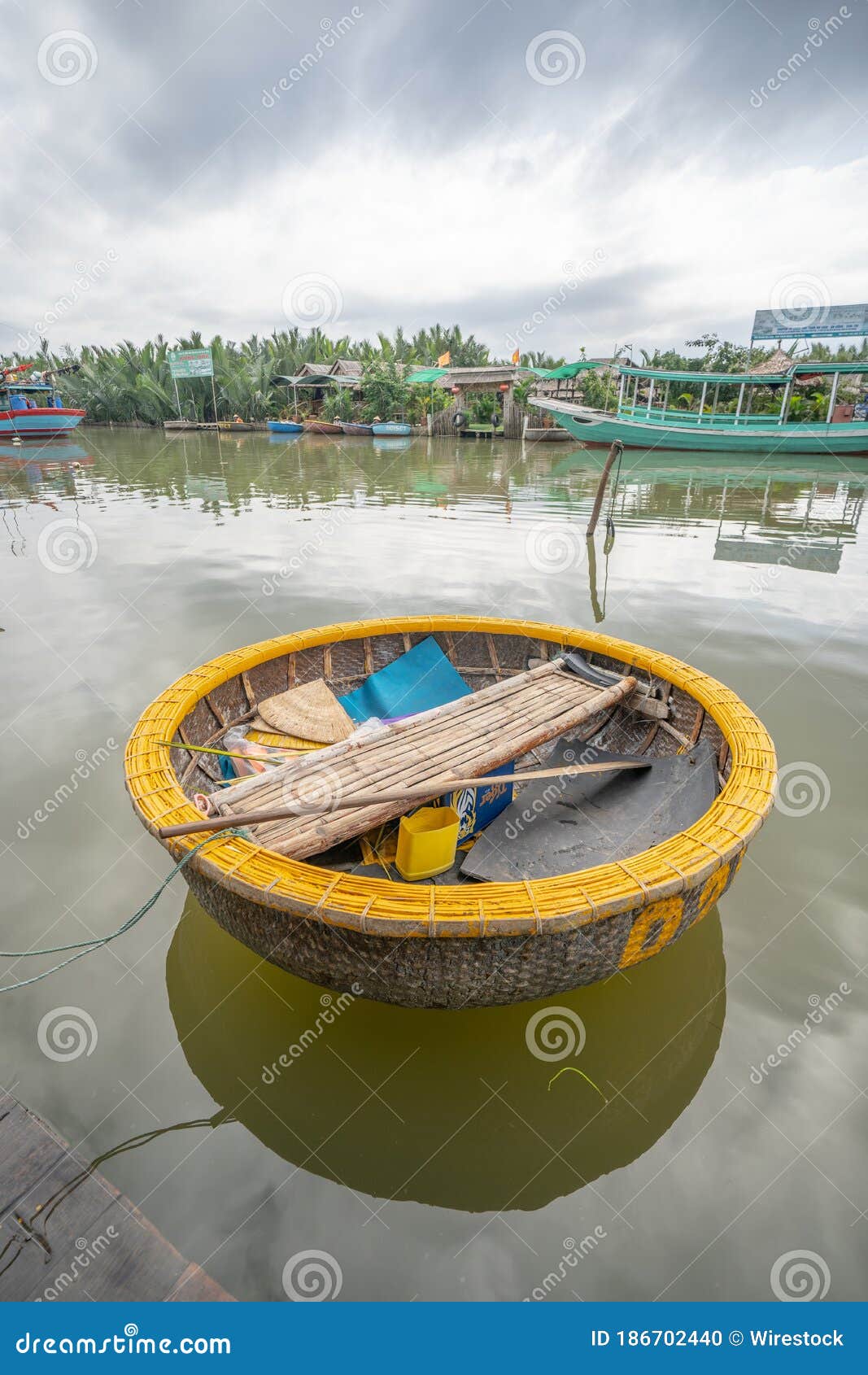 Vertical Shot of a Vietnamese Round Boat in the Lake Stock Photo ...