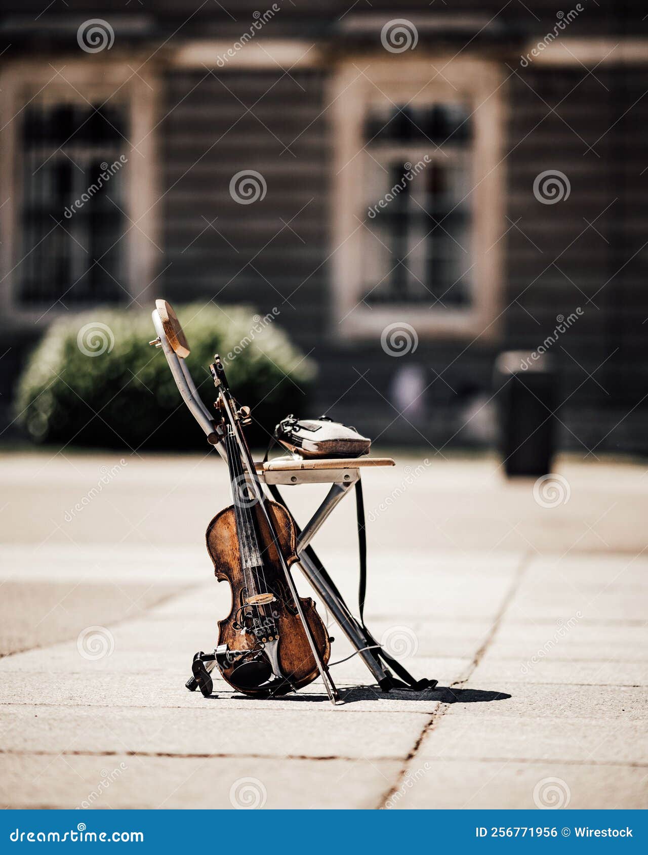 Vertical Shot of a Violin Leaned on a Chair on the Street Stock Photo ...