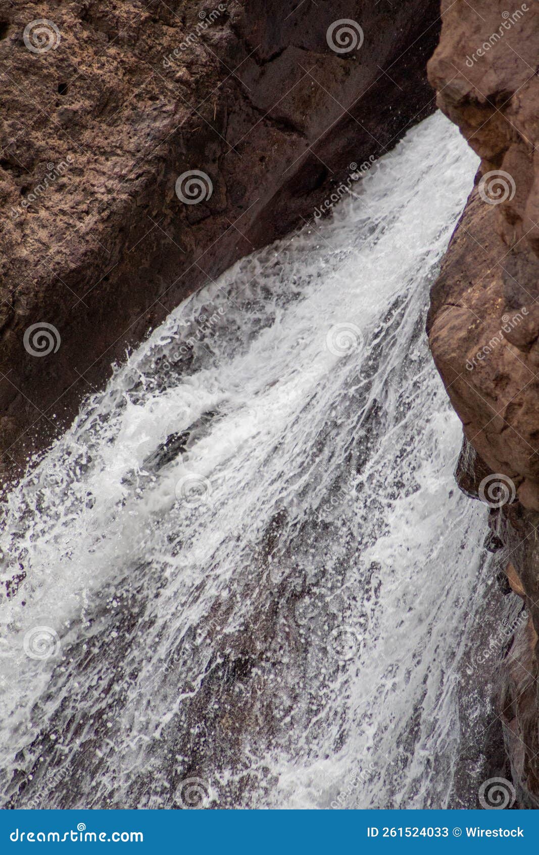 Vertical Shot of a Waterfall Flowing Down the Rocky Slope Stock Image ...