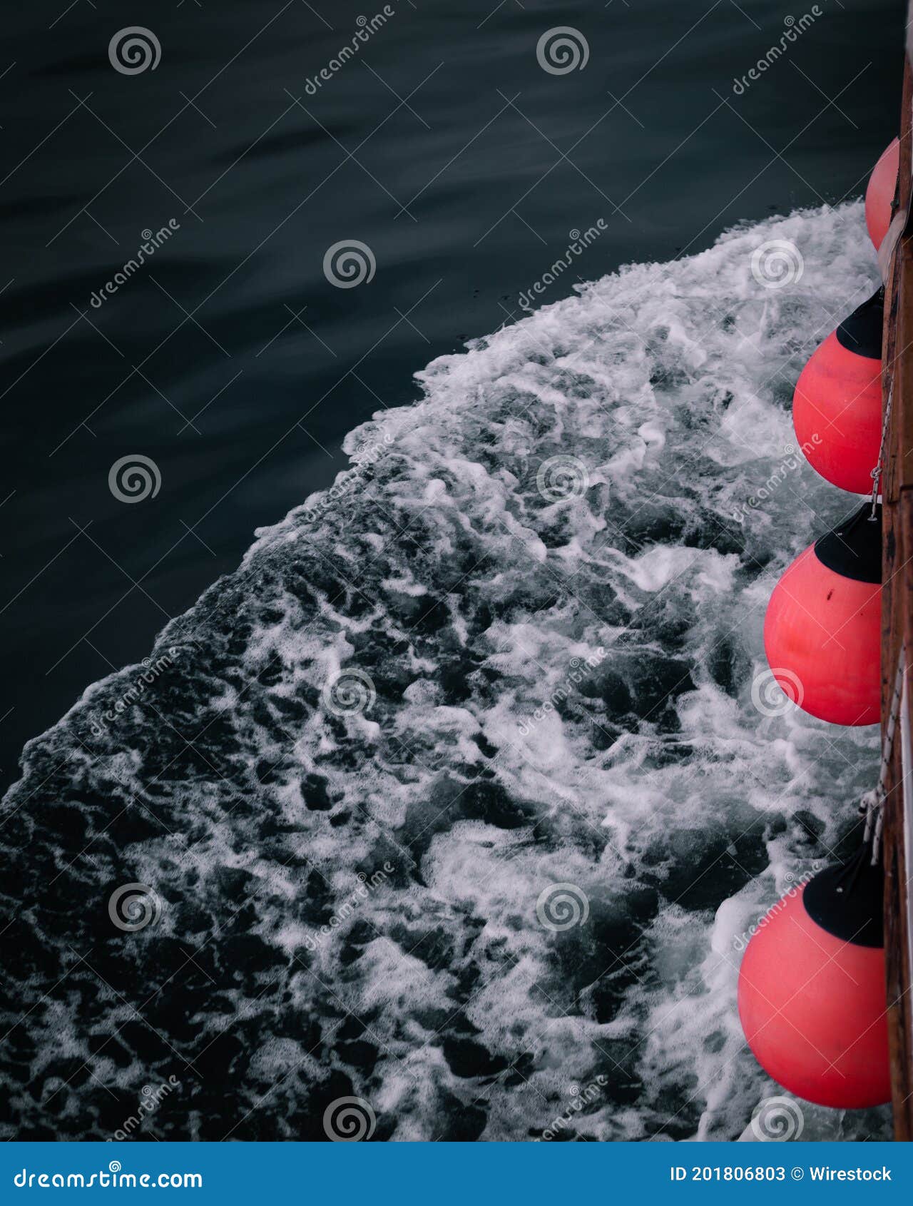 Vertical Shot of Waves Hit by a Ship with Red Buoys on the Side Stock ...