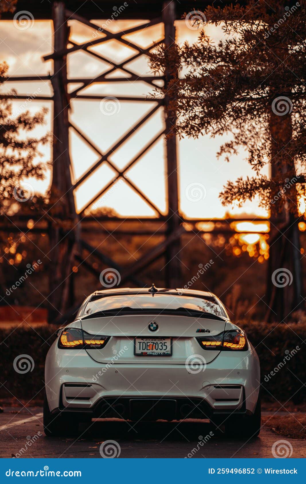 Vertical Shot of a White BMW M4 with a Bridge and a Sunset in the ...