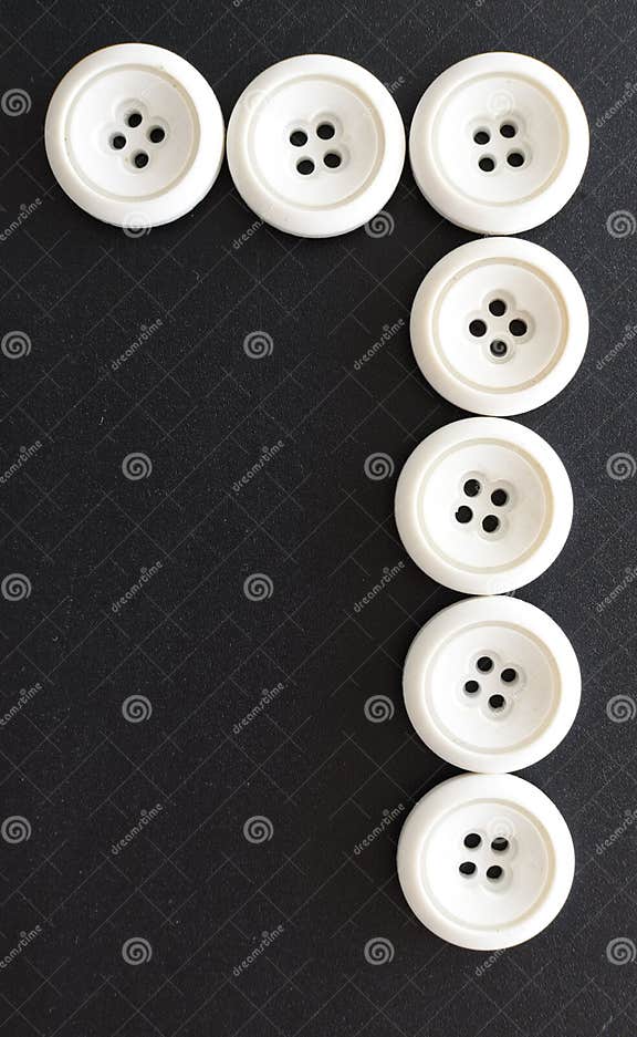 Vertical Shot of White Buttons Assorted Like the Number Seven on a ...