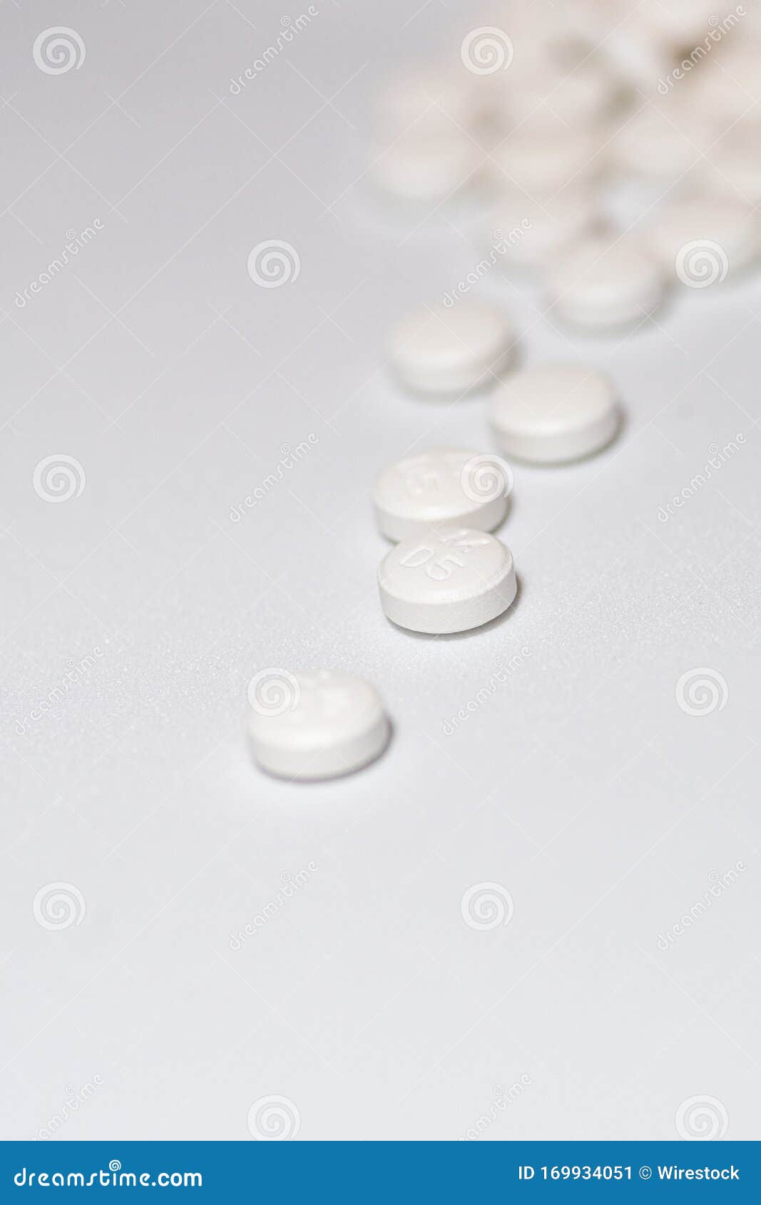 Vertical Shot of White Circular Pills on a White Surface Stock Image ...