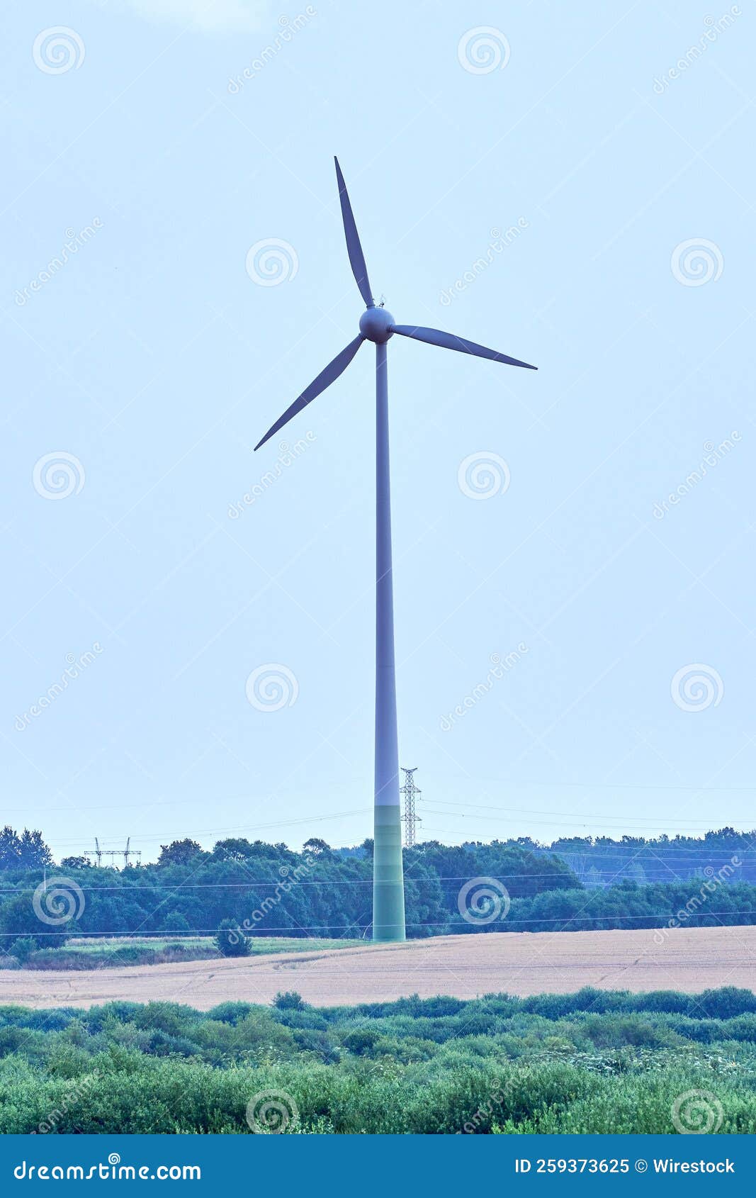 Vertical Shot of a Wind Turbine with Rotating Blades in a Field Stock ...