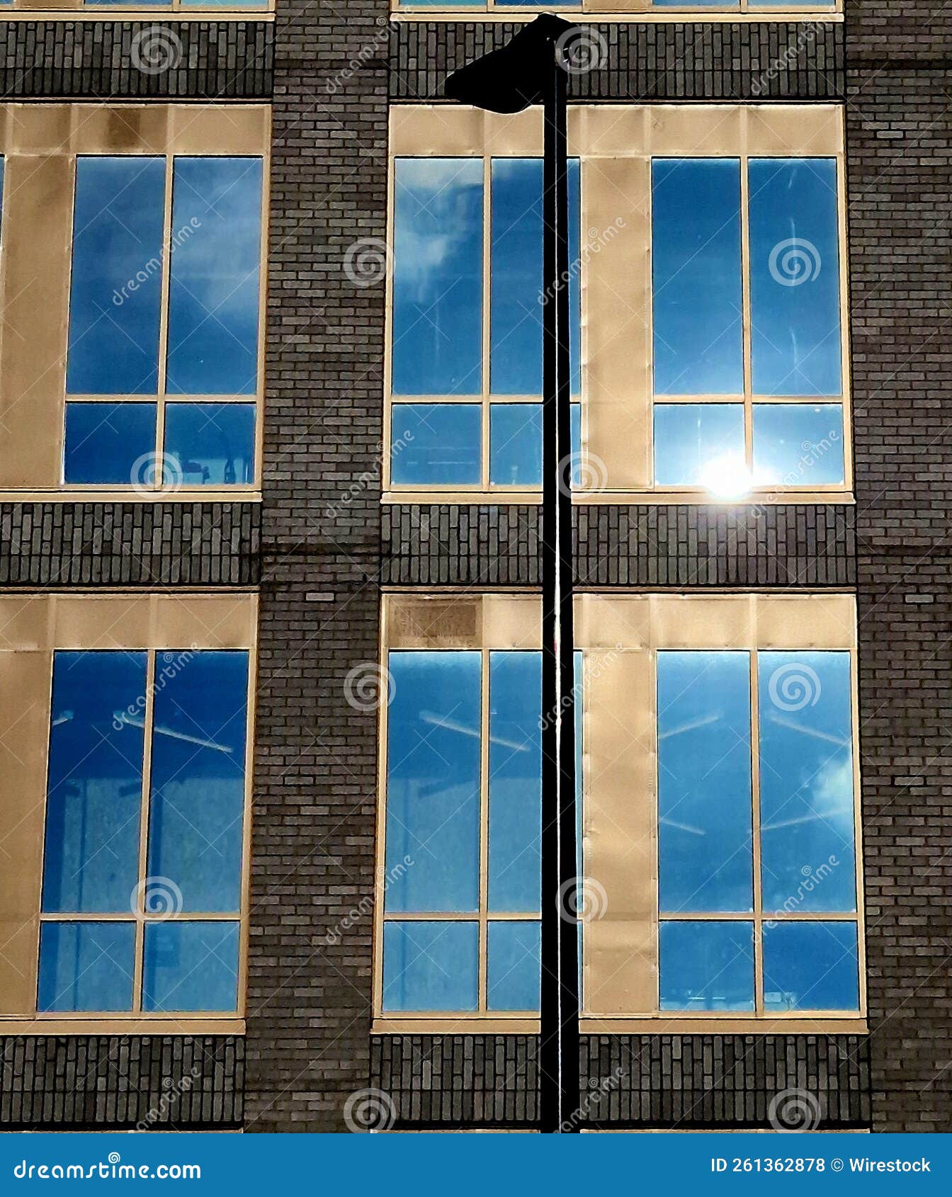 Vertical Shot of Windows of a Modern Brick Building and the Light from ...