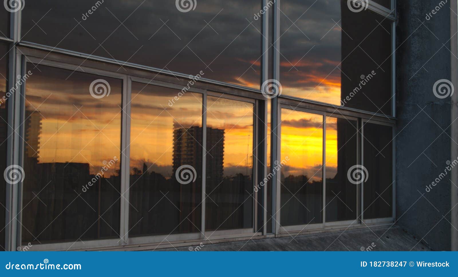 Vertical Shot of Windows with Reflection of the Sunset in it Stock ...