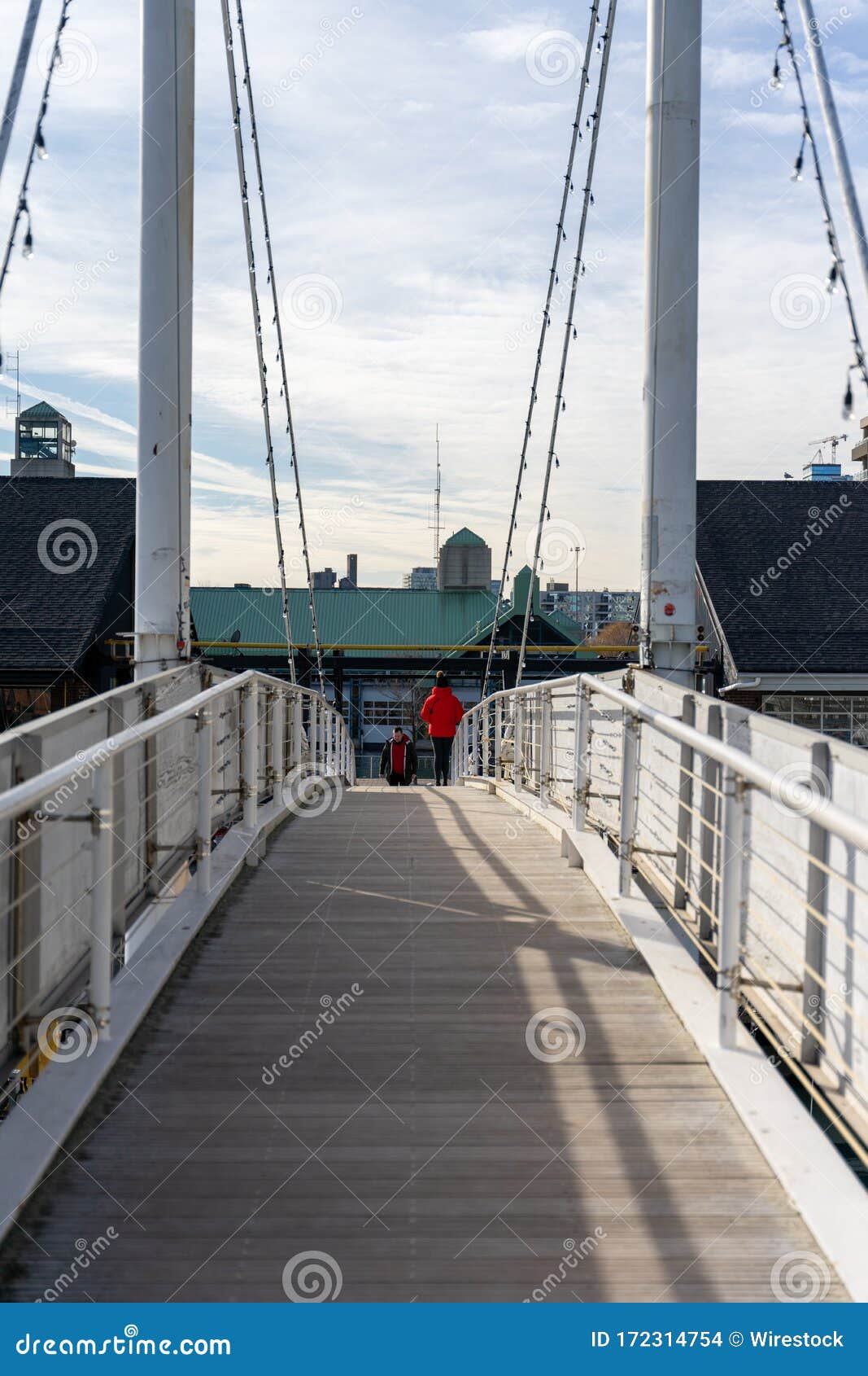 Vertical Shot of the Wooden Footbridge Over a Water Surface Stock Photo ...