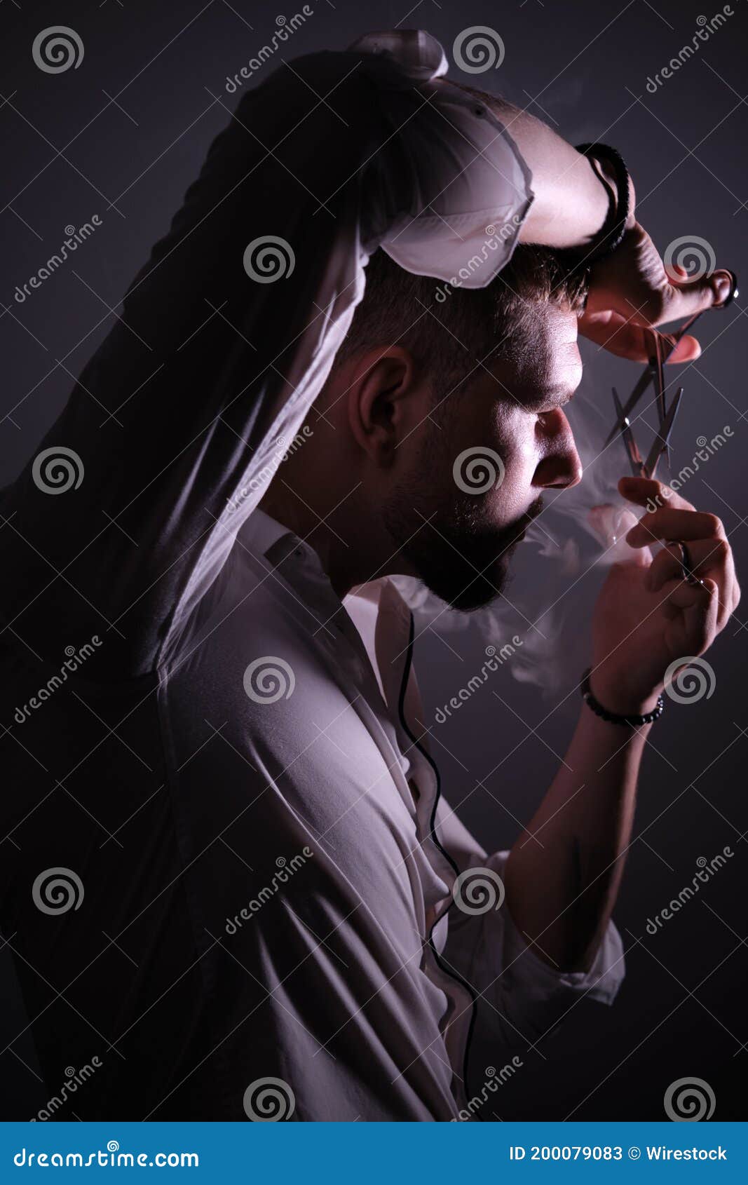 Vertical Shot of a Young Barber Holding Scissors in Front of His Face ...