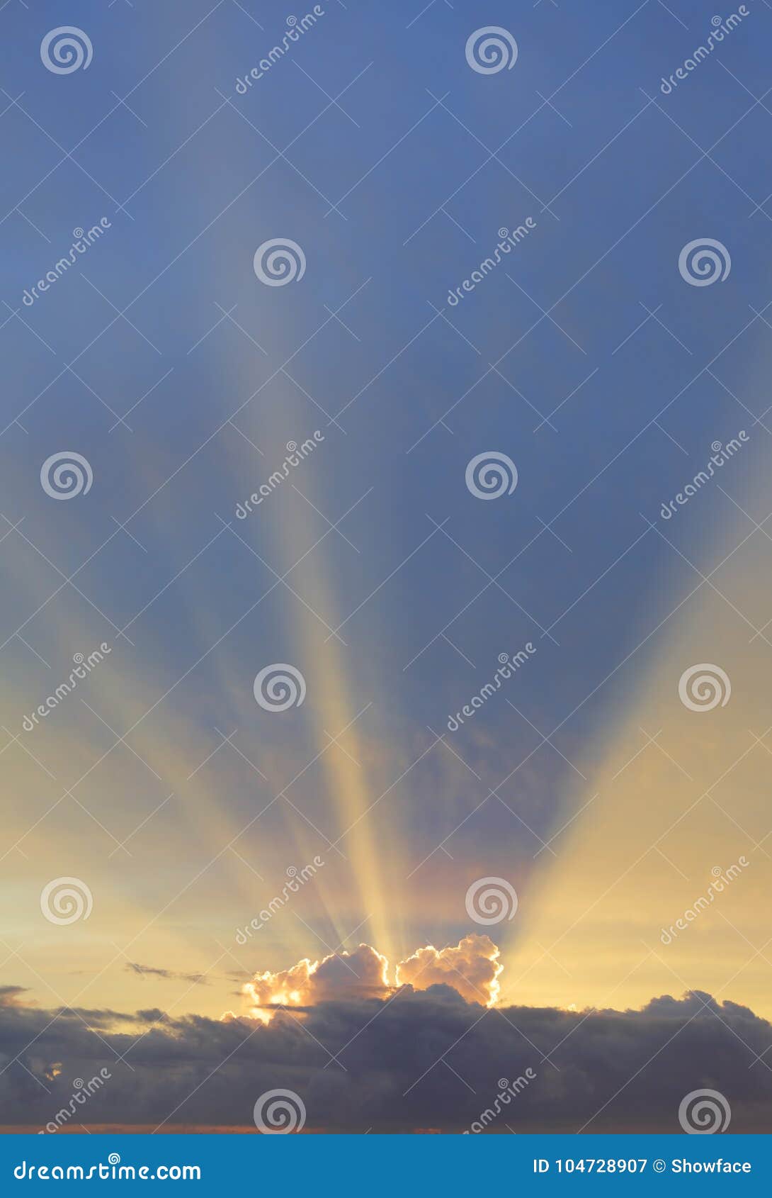 Vertical Sky with Sun Rays Bursting Forth from Behind Clouds Edged with ...