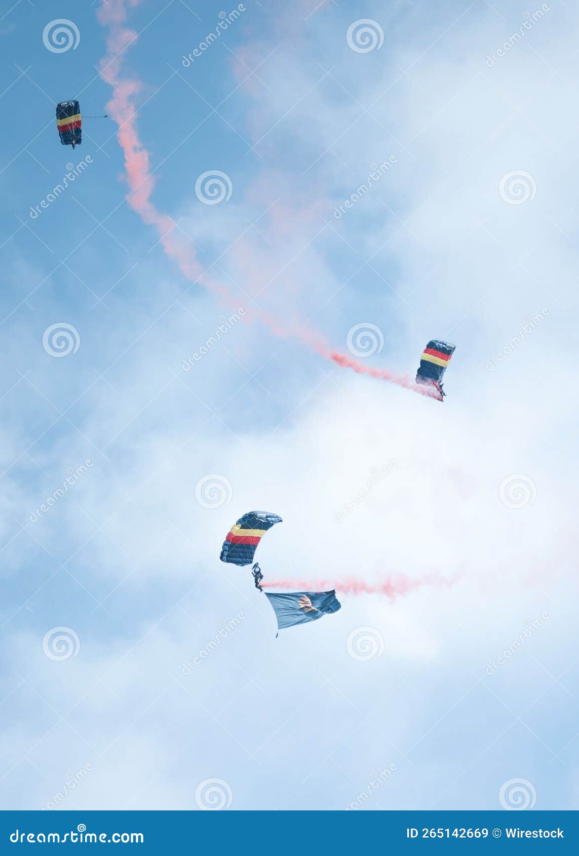 Vertical of Skydivers Diving with a Parachute from the Cloudy Sky Stock ...