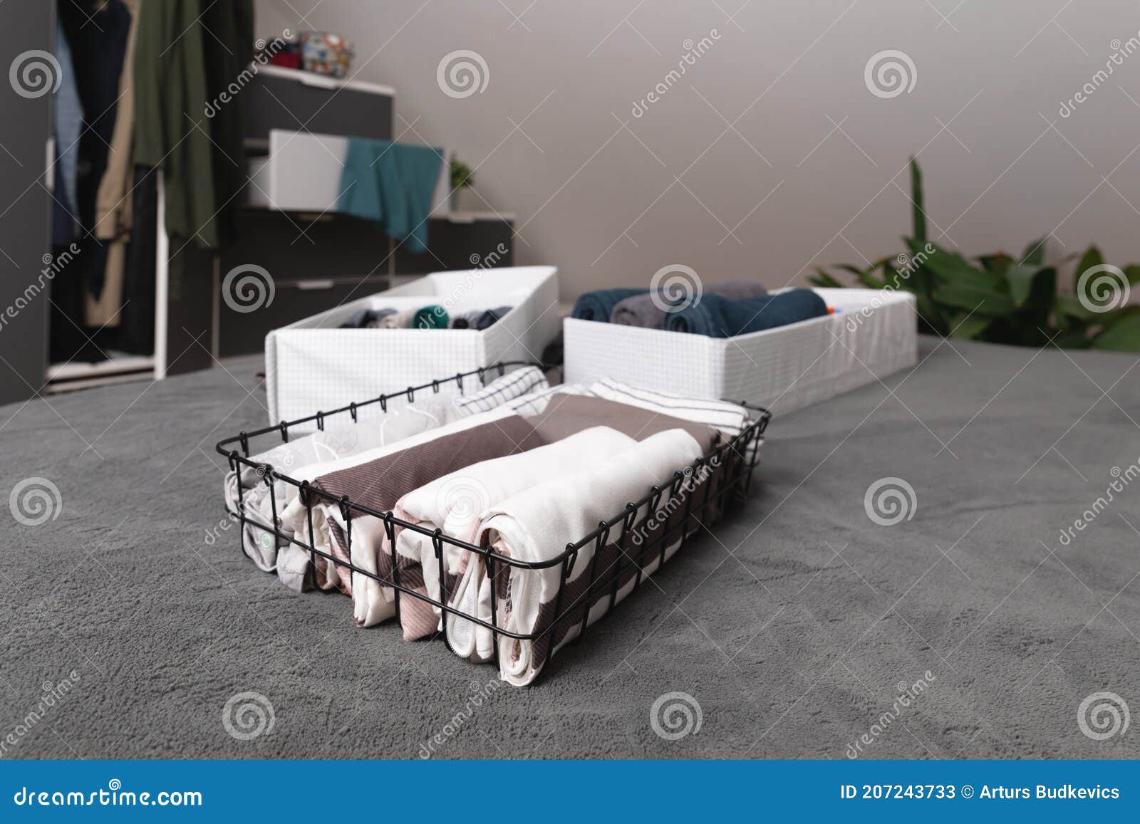 Vertical Storage of Clothing. Sorted Clothes in Baskets and Shelves in ...