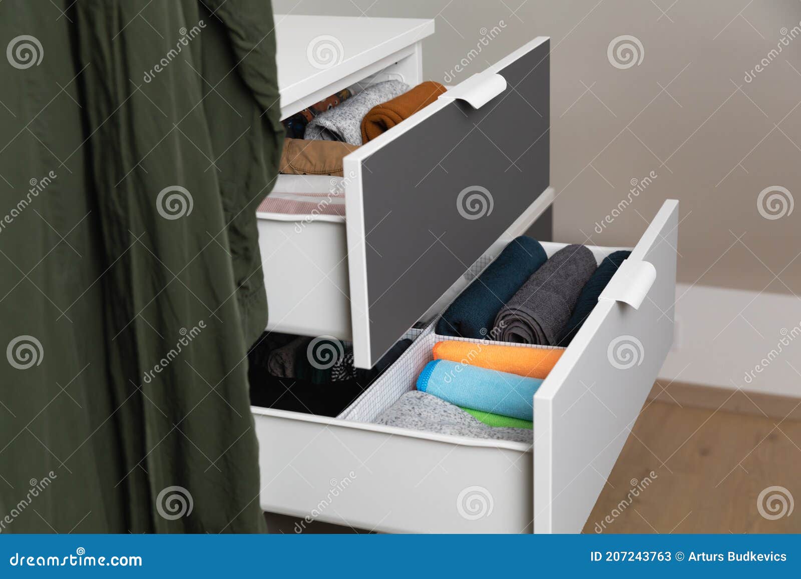 Vertical Storage of Clothing. Sorted Clothes in Baskets and Shelves in ...