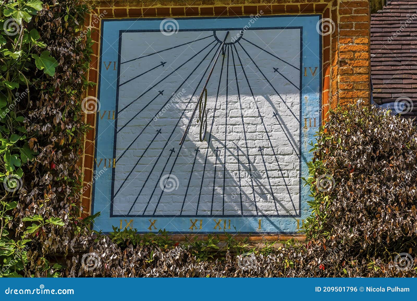 A Vertical Sundial on a Wall in Warwickshire. UK Stock Photo - Image of ...