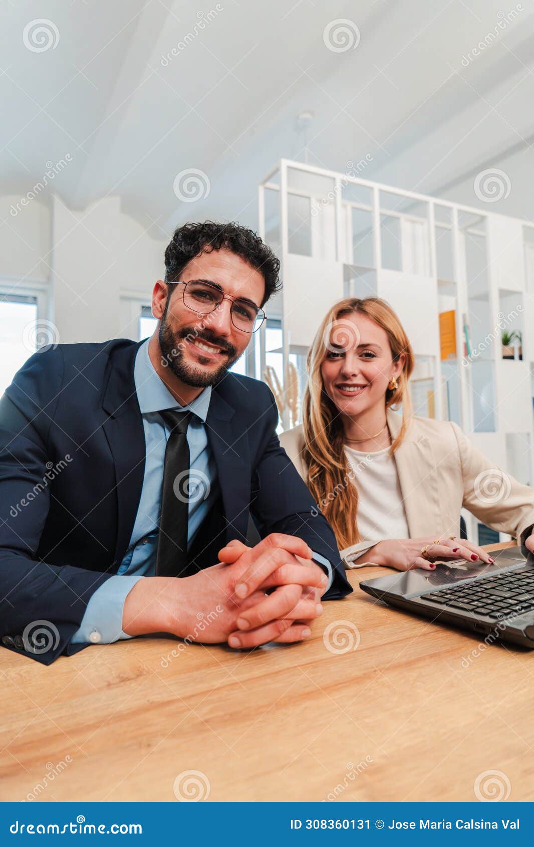 Vertical. Teamwork of Businesspeople Sitting on Desk and Looking at ...