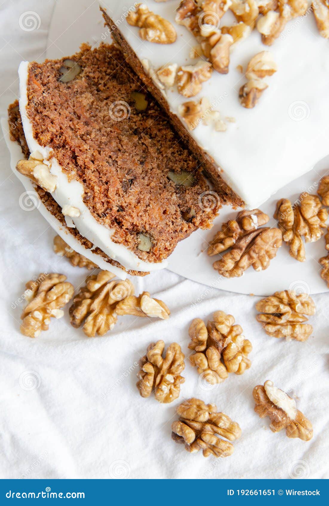 Vertical Top View of a Cake with White Icing and Walnuts on a White ...