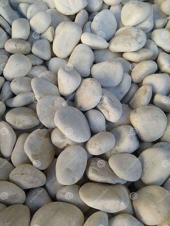 Vertical Top View of a Collection of White Rocks Placed on Some Surface ...