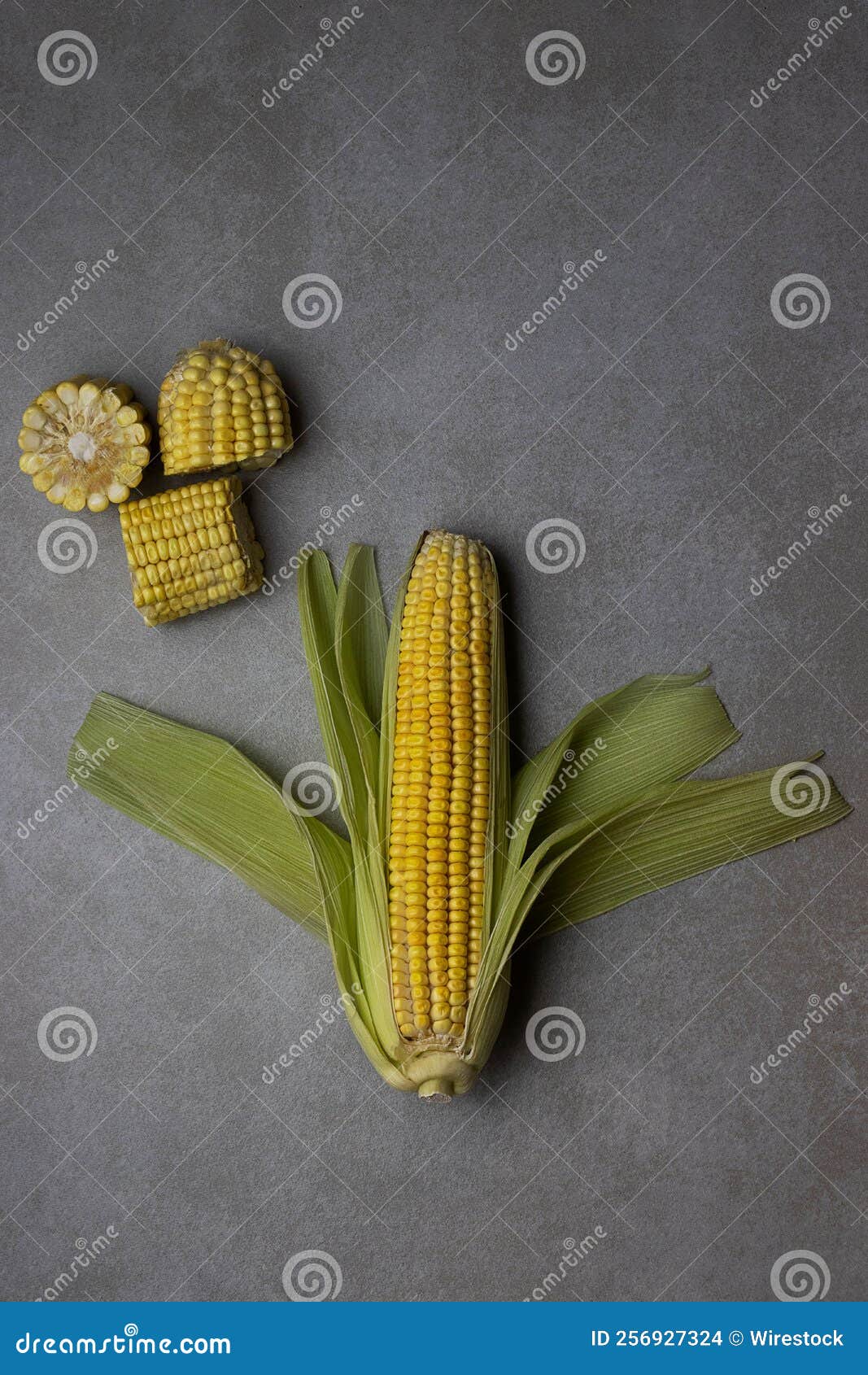 Vertical Top View of Corn in Its Leaves on a Gray Surface Stock Photo ...
