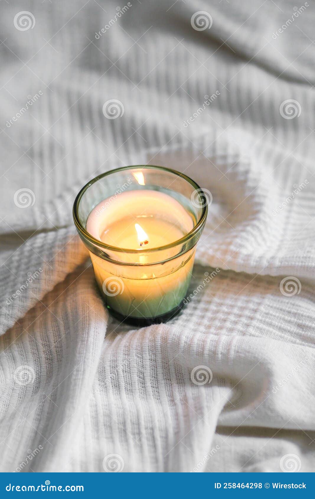 Vertical Top View of a Litten Candle on a White Comforter Stock Photo ...