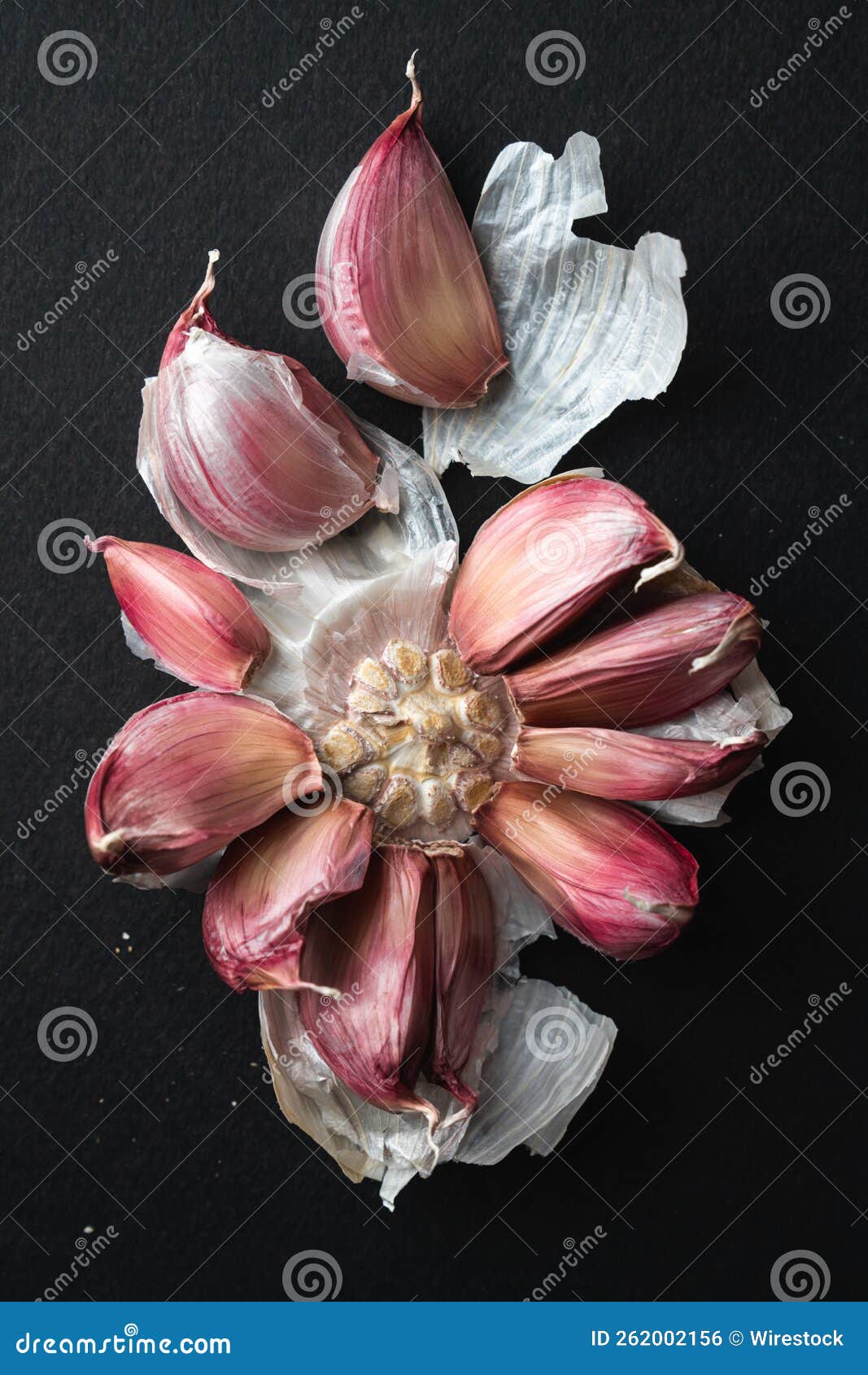 Vertical Top View of a Peeled Red Garlic on a Black Surface Stock Photo ...