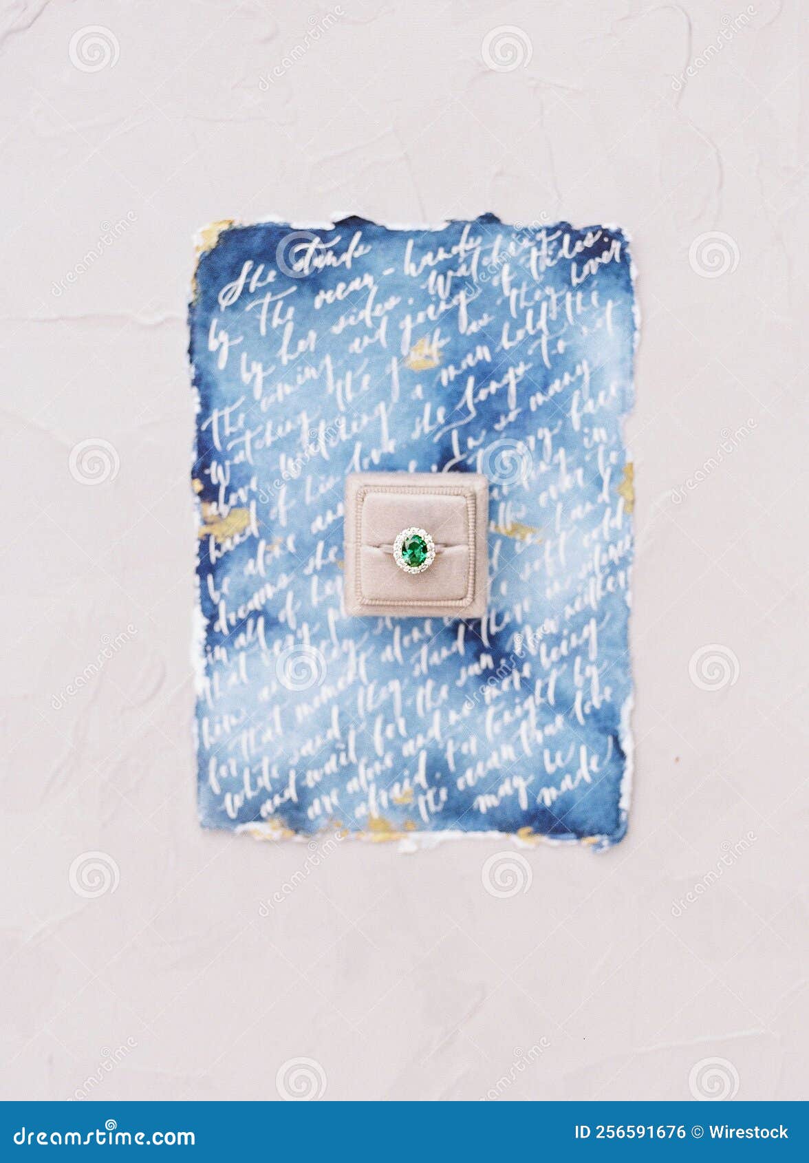 Vertical Top View of Ring with an Emerald Gemstone on a Blue Postcard ...