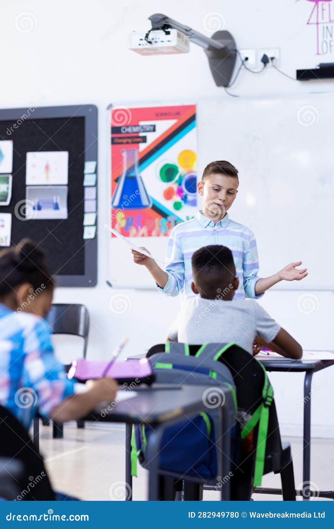 Vertical of Two Diverse Schoolboys in Discussion during Class with Copy ...
