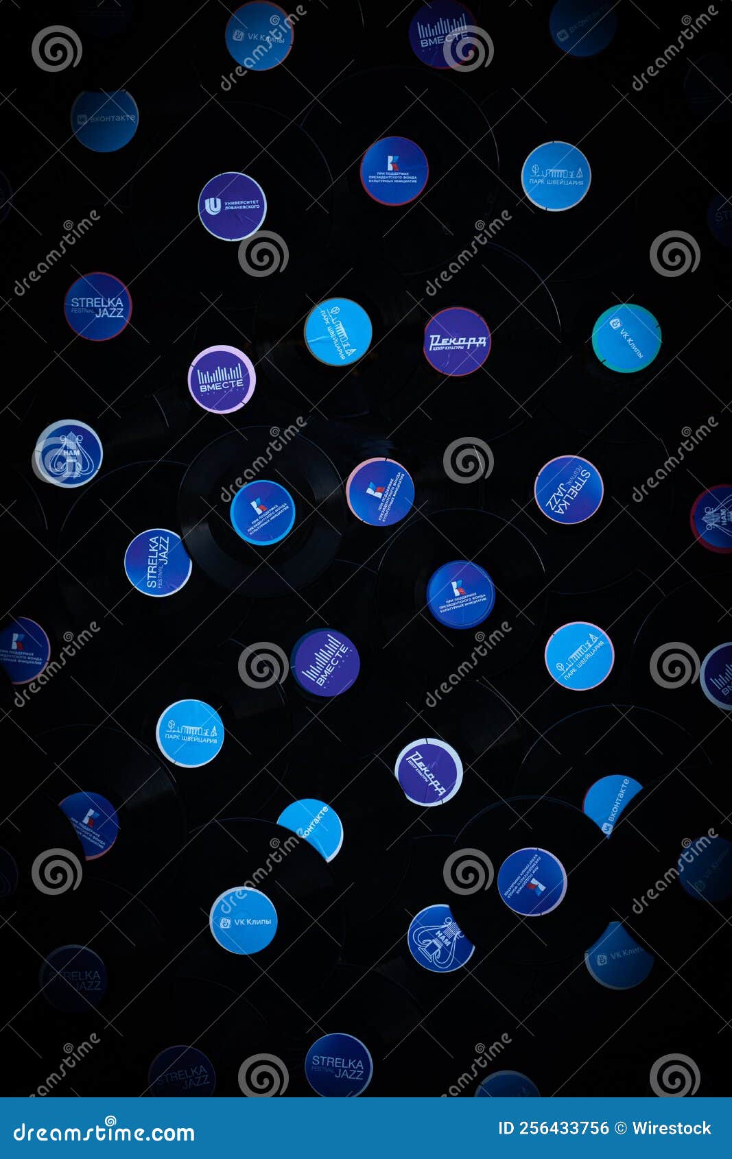 Vertical View of Blue Circle Stickers of Different Logos on the Black ...