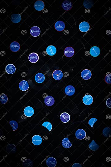 Vertical View of Blue Circle Stickers of Different Logos on the Black ...