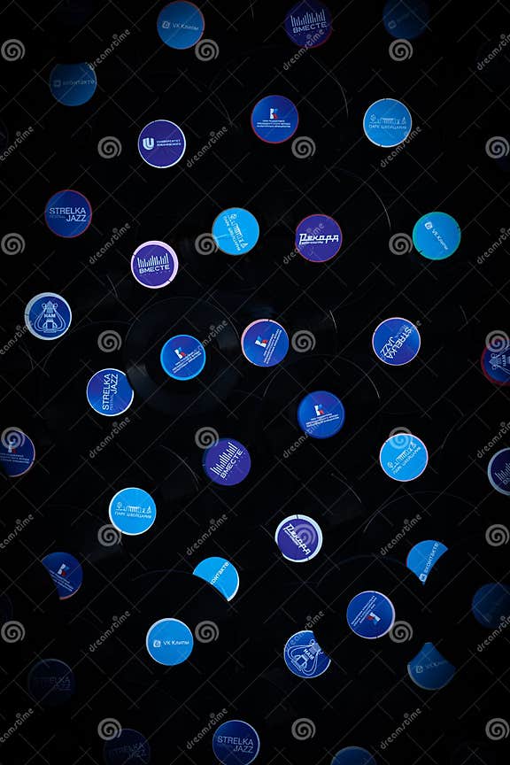 Vertical View of Blue Circle Stickers of Different Logos on the Black ...