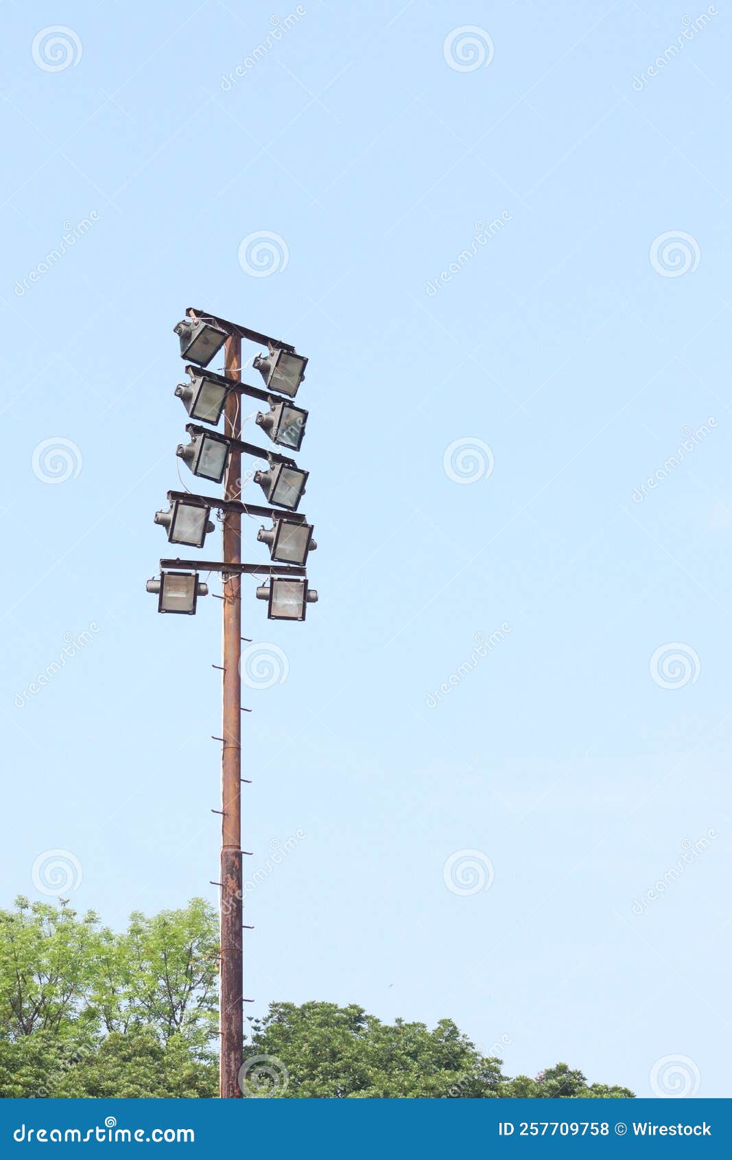 Vertical View of a Column with Projector Lights before the Blue Sky ...