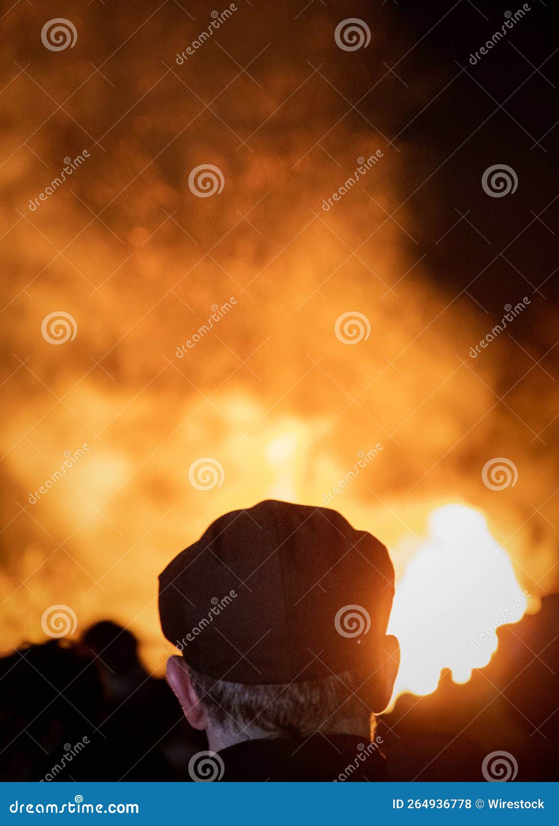 Vertical View of the Crowd Standing before the Roaring Bonfire Flames ...