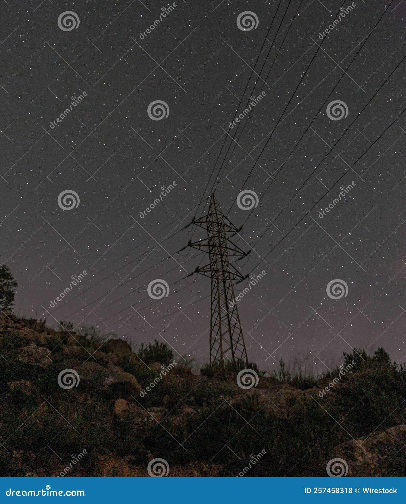 Vertical View of an Electricity Column Over the Hill Under the Starry ...
