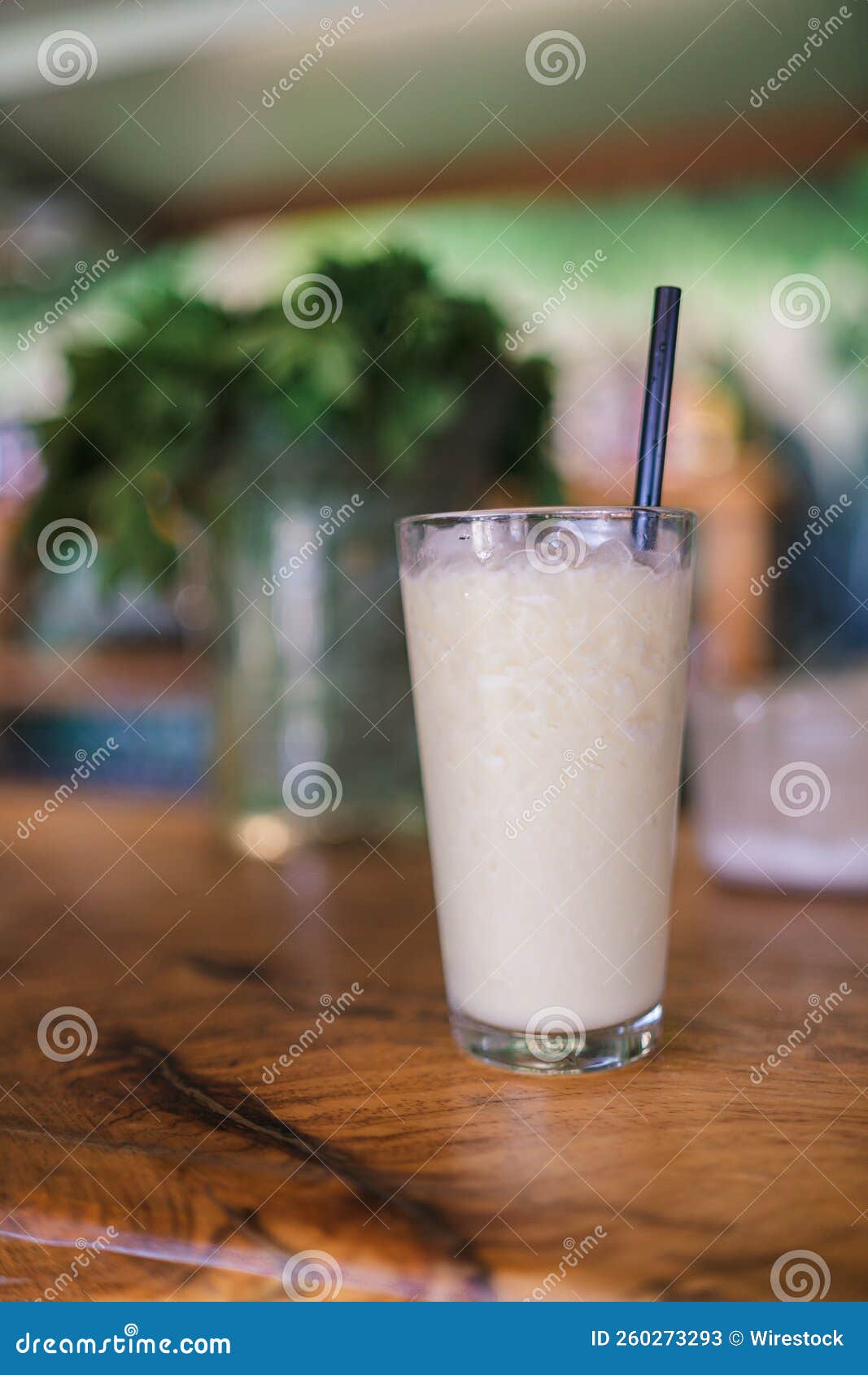 Vertical View of a Glass of White Cold Drink Over a Wooden Surface ...