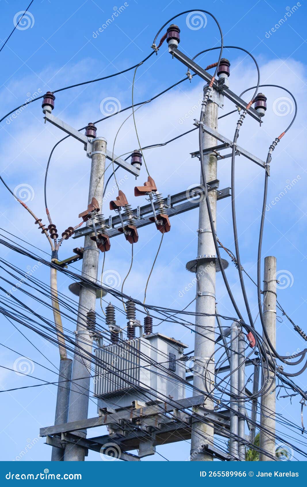 Vertical View Looking Up at Electrical Poles and Wiring Against a Blue ...