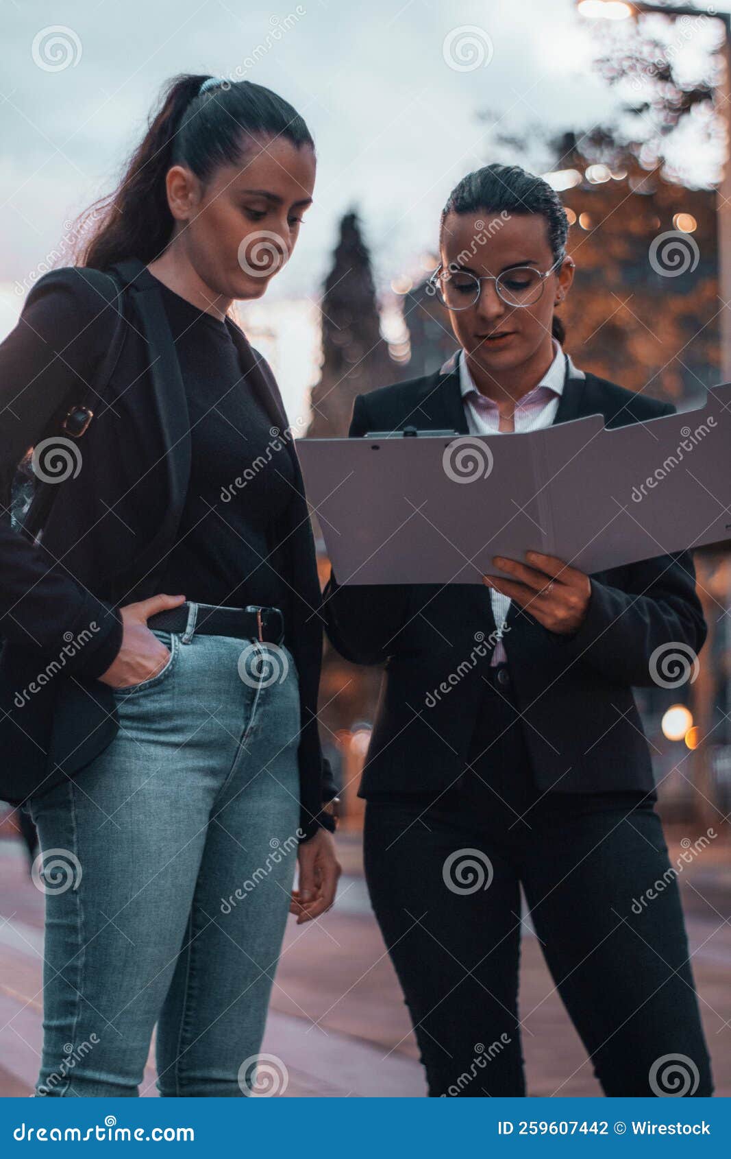 Vertical View of Two Female Students Checking on a Task while Standing ...