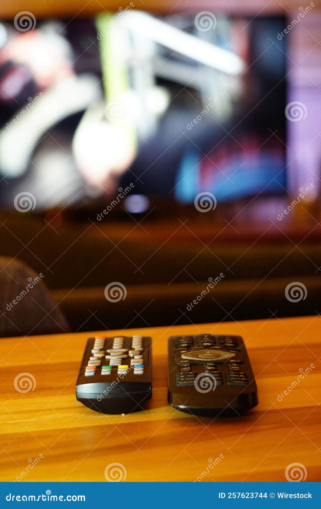 Vertical View of Two Television Remote Controllers on the Wooden Table ...