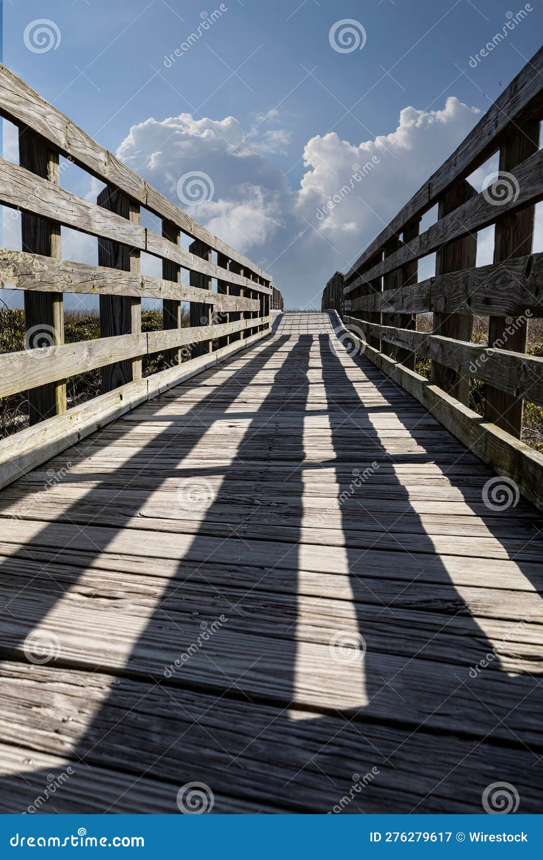 Vertical of a Wooden Boardwalk Across the Beach, with a Clear Sky ...