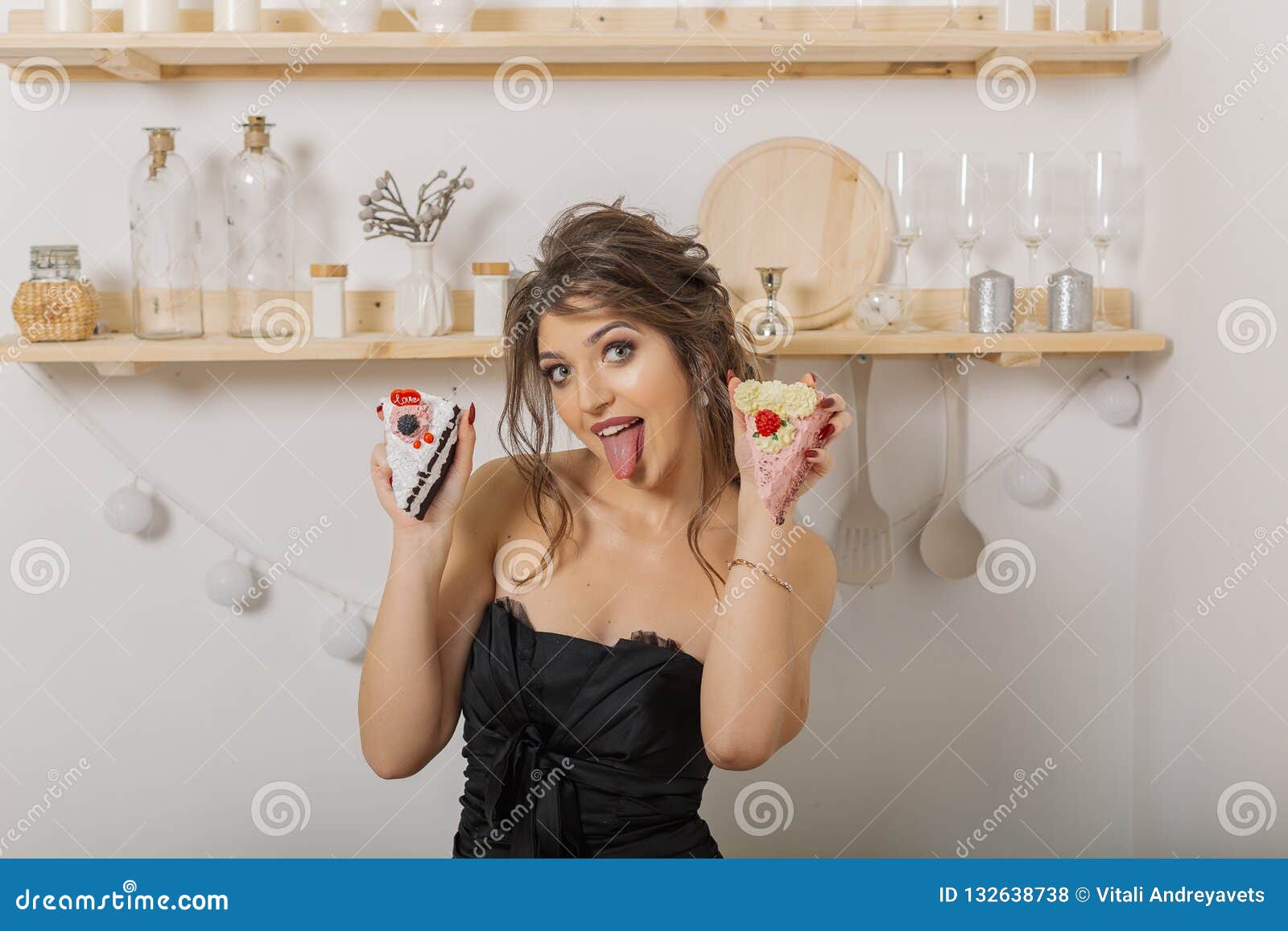 Very Beautiful And Cheerful Woman Holding Cakes In Her Hands And