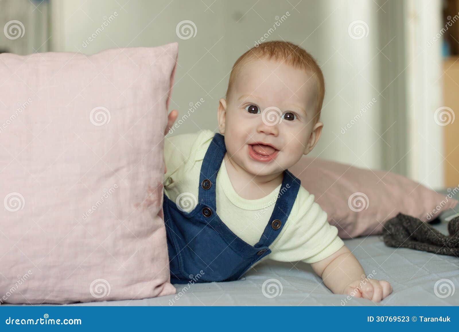 Very Curious Baby Stares while Playing with Pillows Stock Image - Image ...