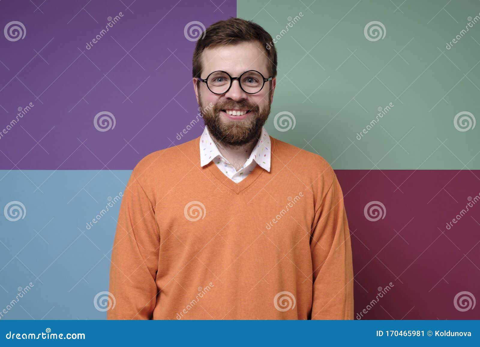 Very Cute Caucasian Bearded Man In Round Glasses In An Orange Sweater