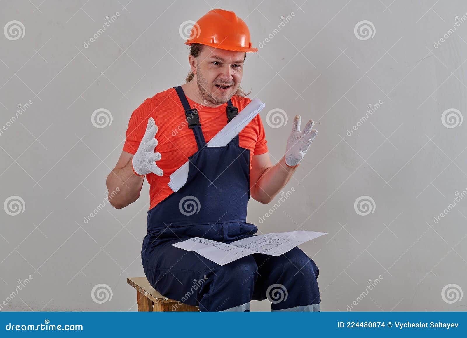A Very Grumpy Engineer Examines Project Drawings Carefully Stock Photo ...