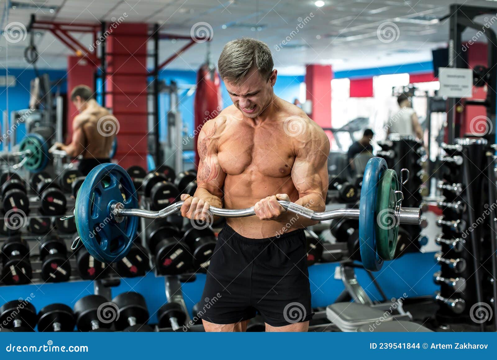 Very Power Athletic Guy Standing Workout in the Gym. Stock Photo ...