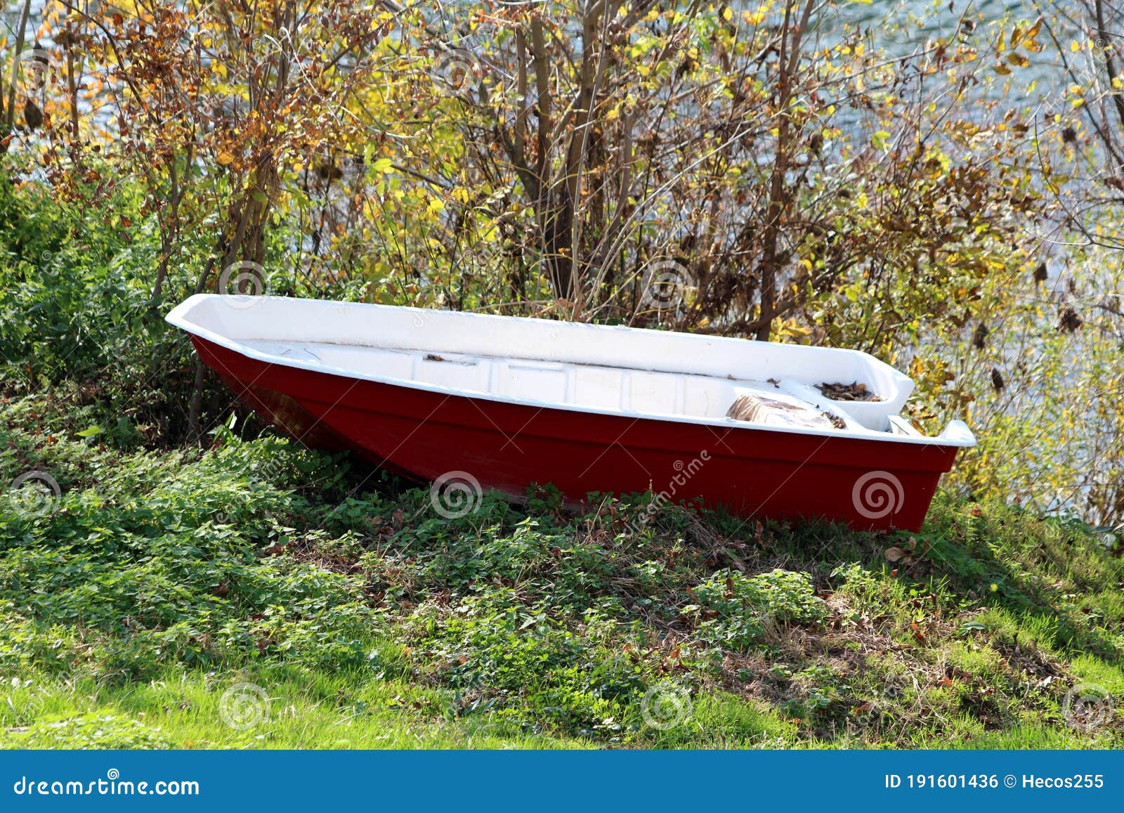 Very Small Plastic White and Red River Boat Left on Side of River Bank ...
