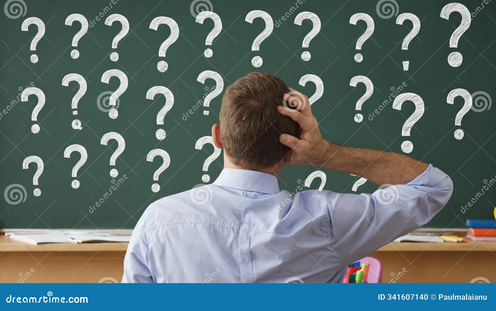 A Very Stressed Man, in Front of a Chalkboard with Drawn Question Marks ...