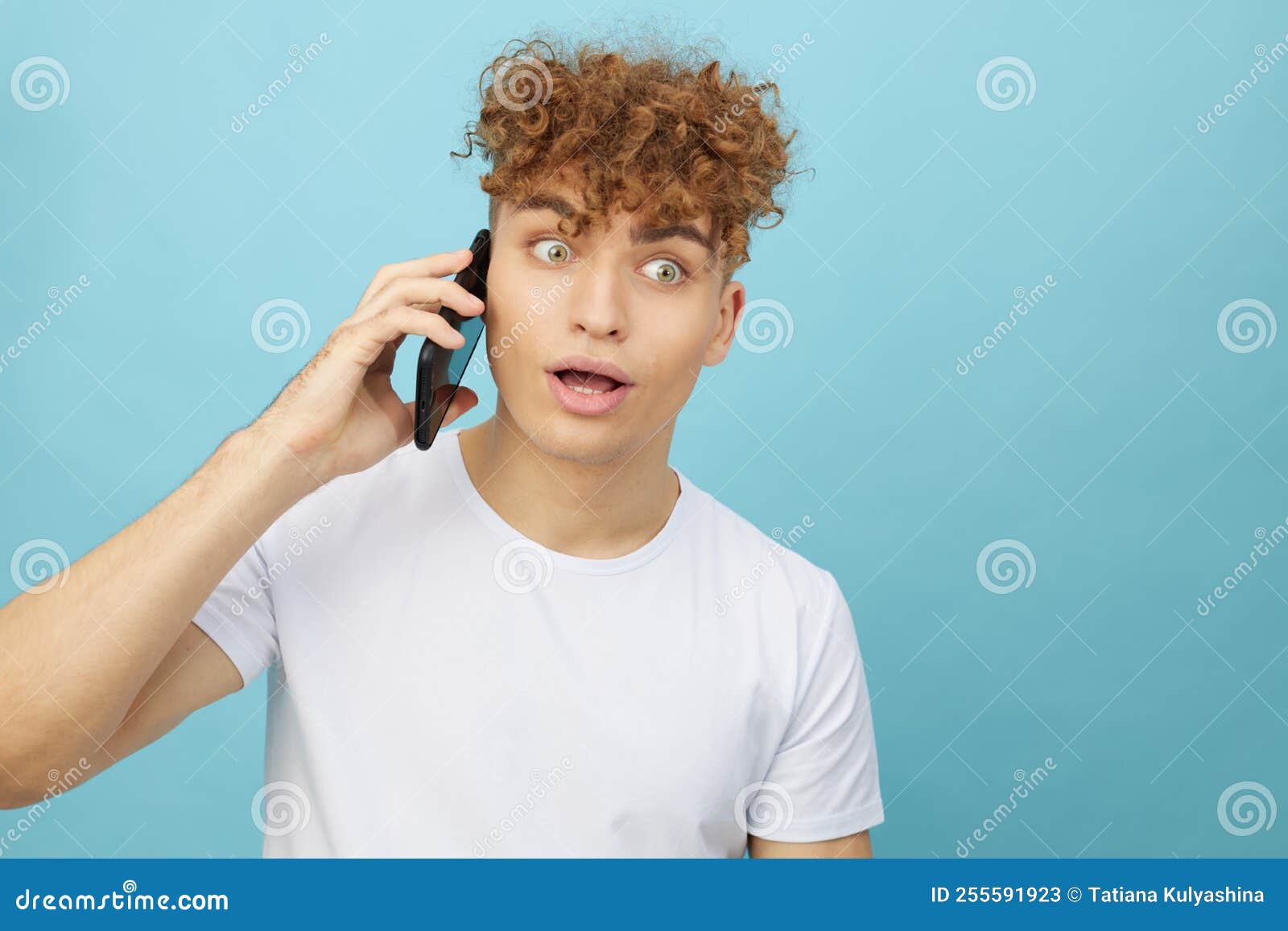 A Very Surprised Shocked Man Stands On A Light Blue Background Talking