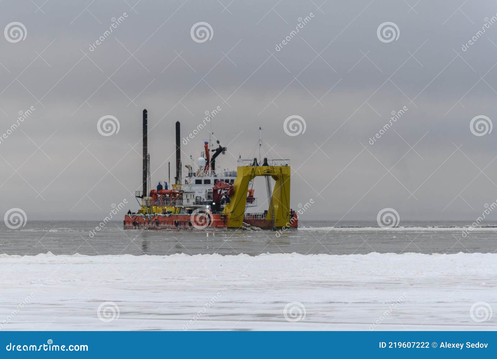 Vessel Engaged in Dredging at Sunset Time. Hopper Dredger Working at ...
